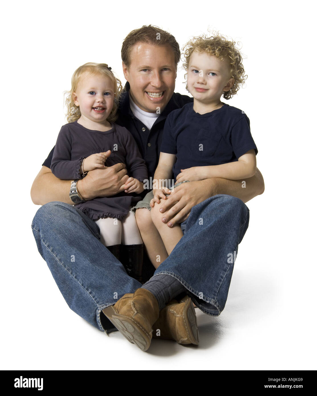 Portrait of a father sitting with his son and his daughter Stock Photo ...