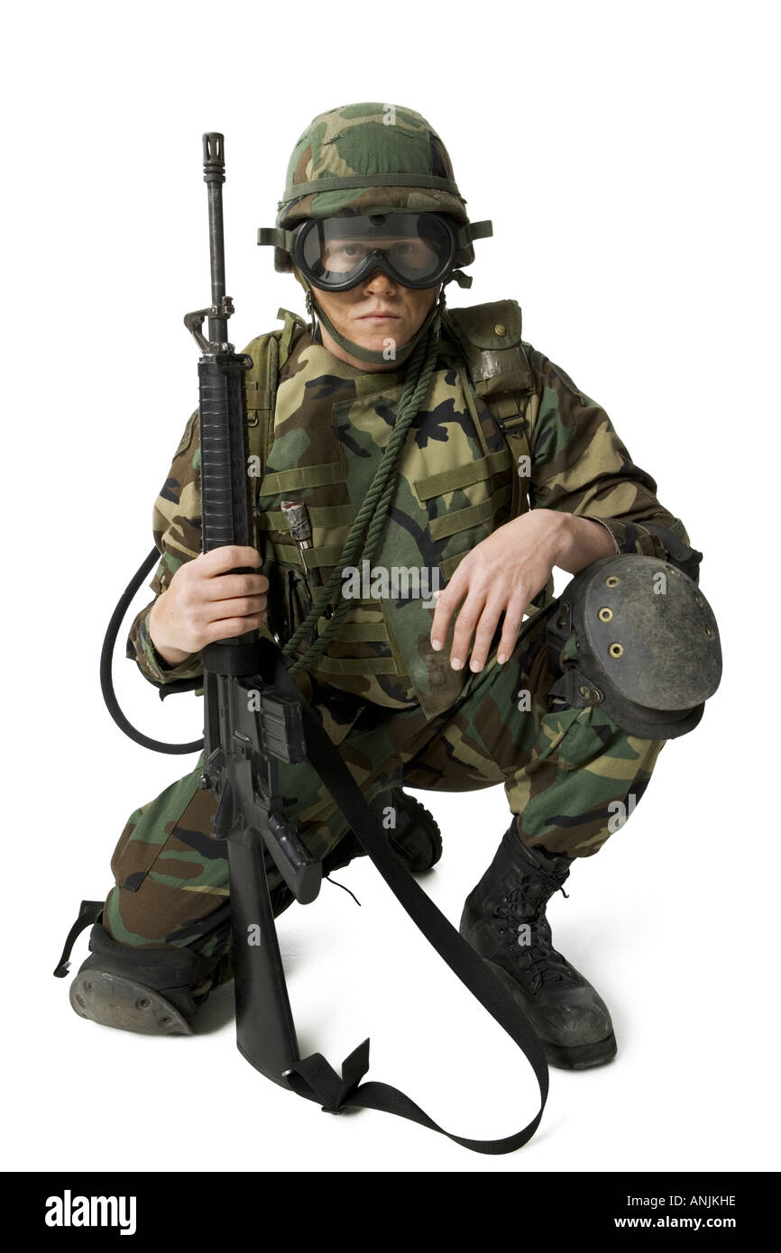 Portrait of a soldier kneeling and holding a rifle Stock Photo - Alamy