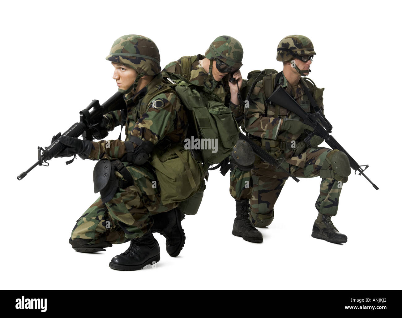 Three soldiers crouching and holding rifles Stock Photo - Alamy