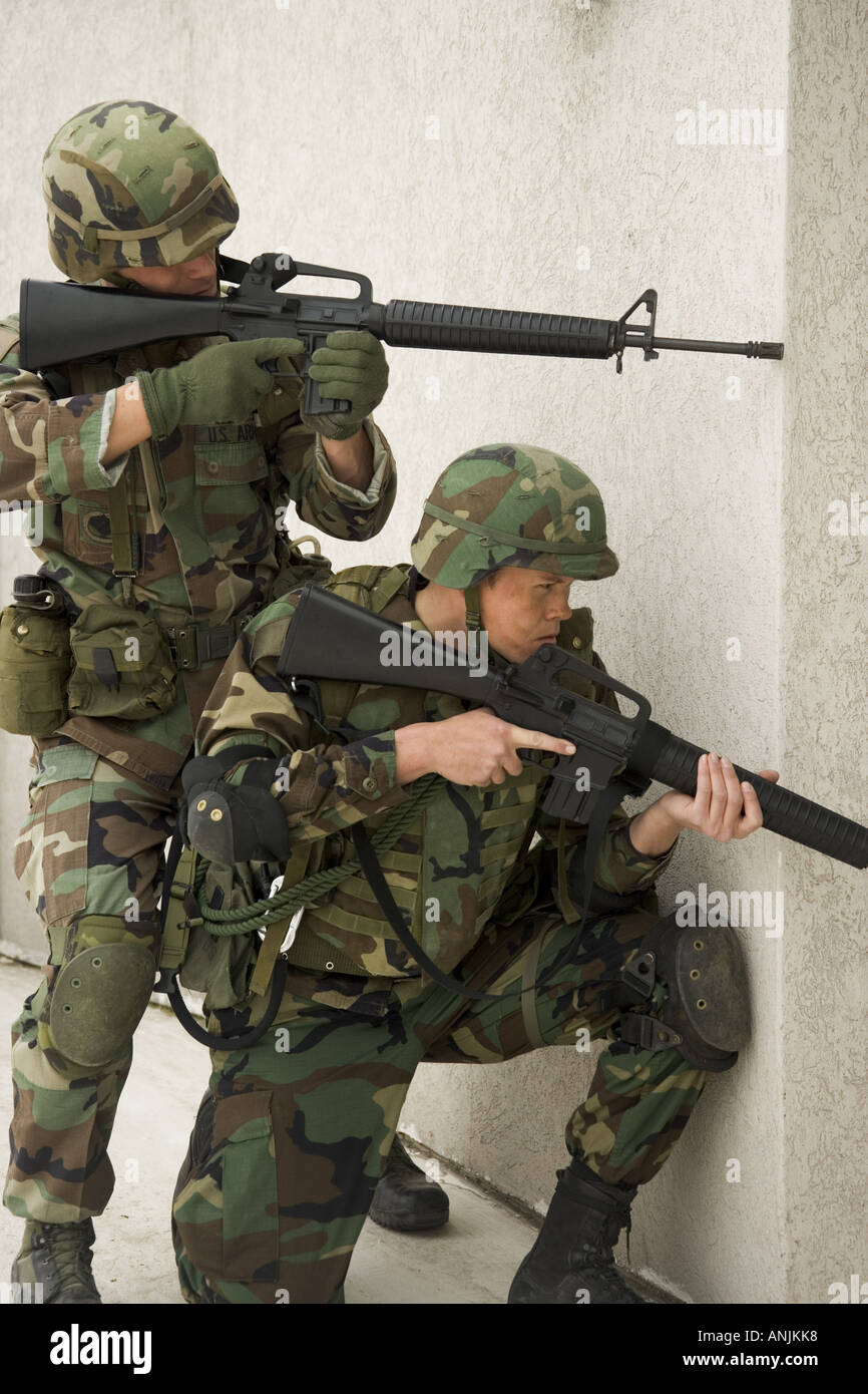Two soldiers aiming their rifles Stock Photo - Alamy