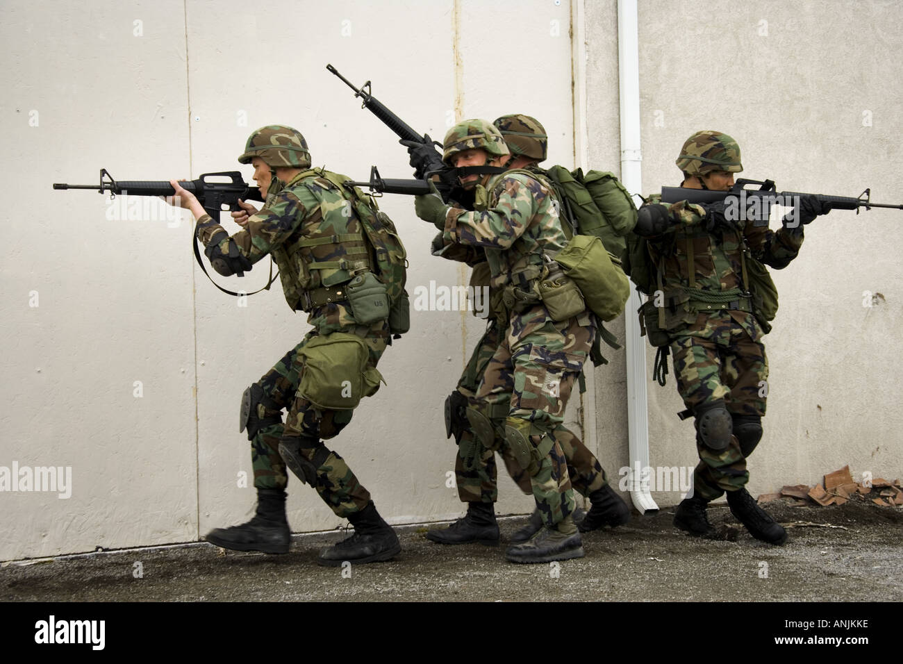 Four soldiers aiming their rifles Stock Photo - Alamy