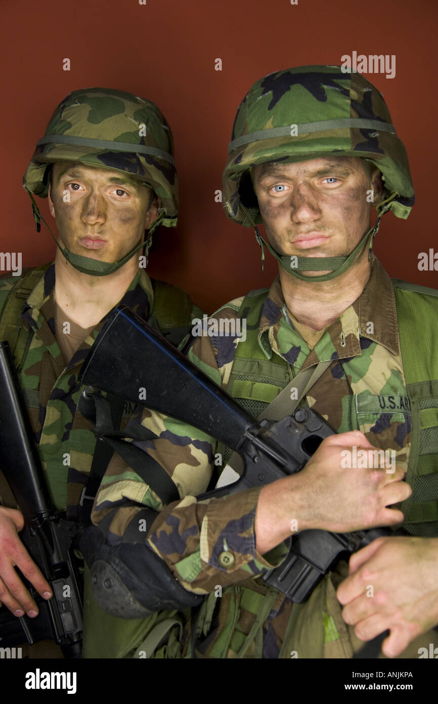 Portrait of two soldiers holding their rifles Stock Photo - Alamy