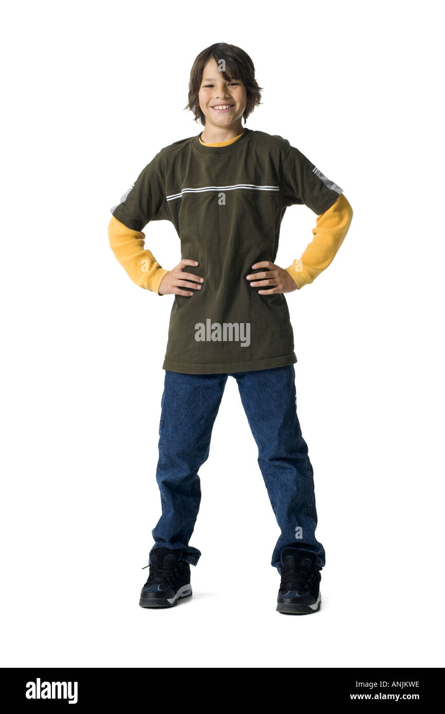 Portrait of a boy standing with arms akimbo Stock Photo - Alamy