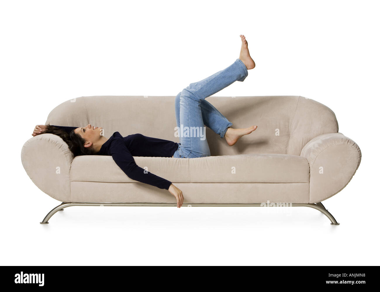 Side profile of a young woman lying on a couch Stock Photo - Alamy