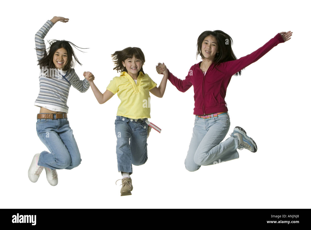 Portrait of three girls jumping Stock Photo - Alamy