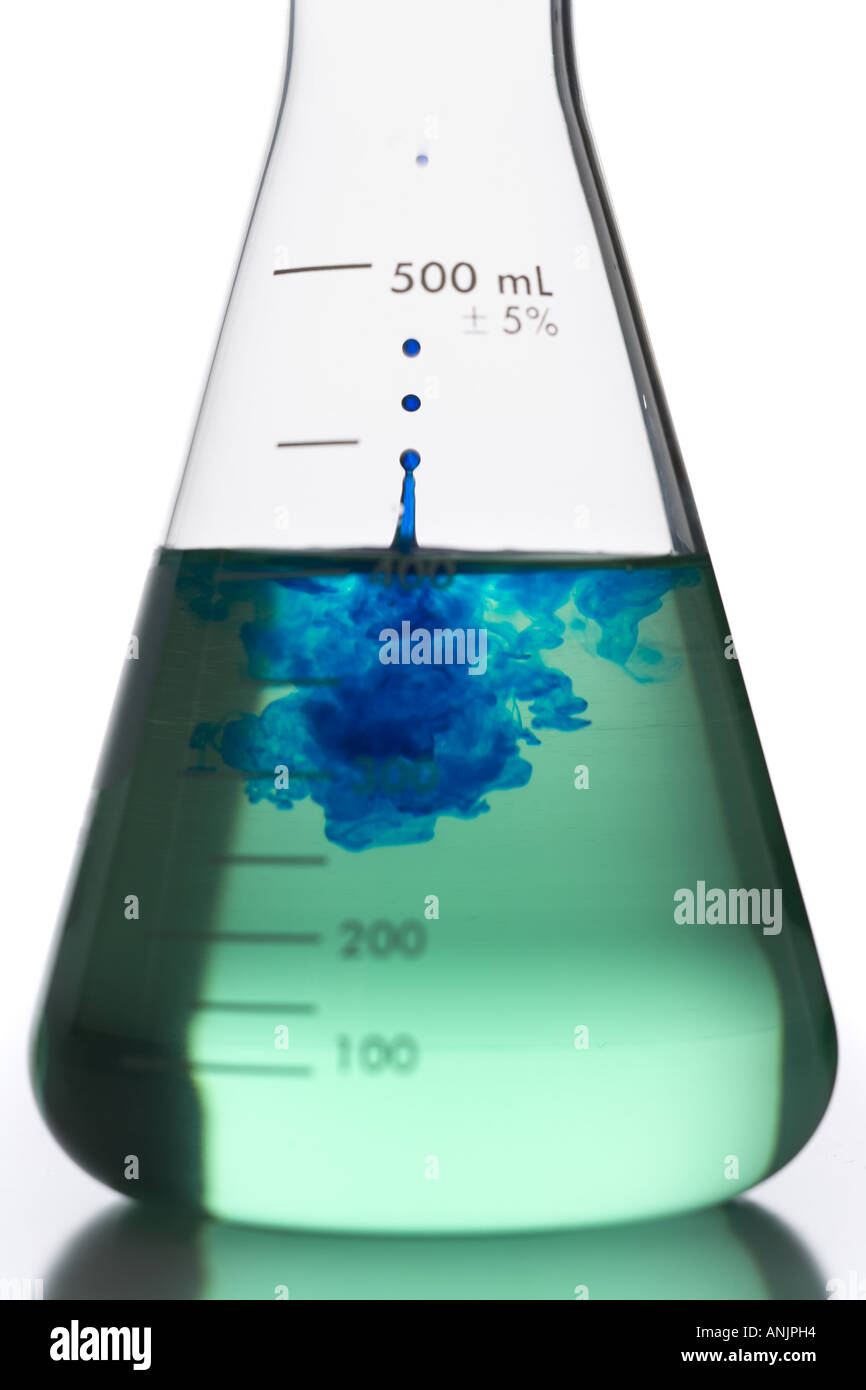 Liquid being poured into a conical flask with a test tube Stock Photo ...