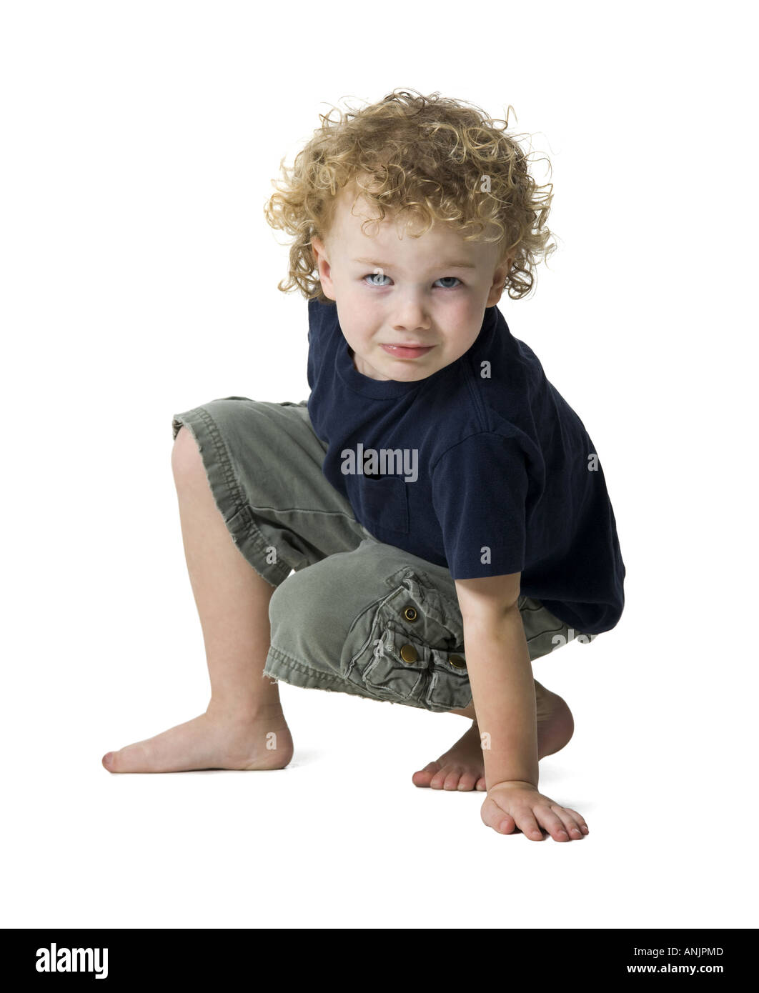 Portrait of a boy crouching Stock Photo - Alamy