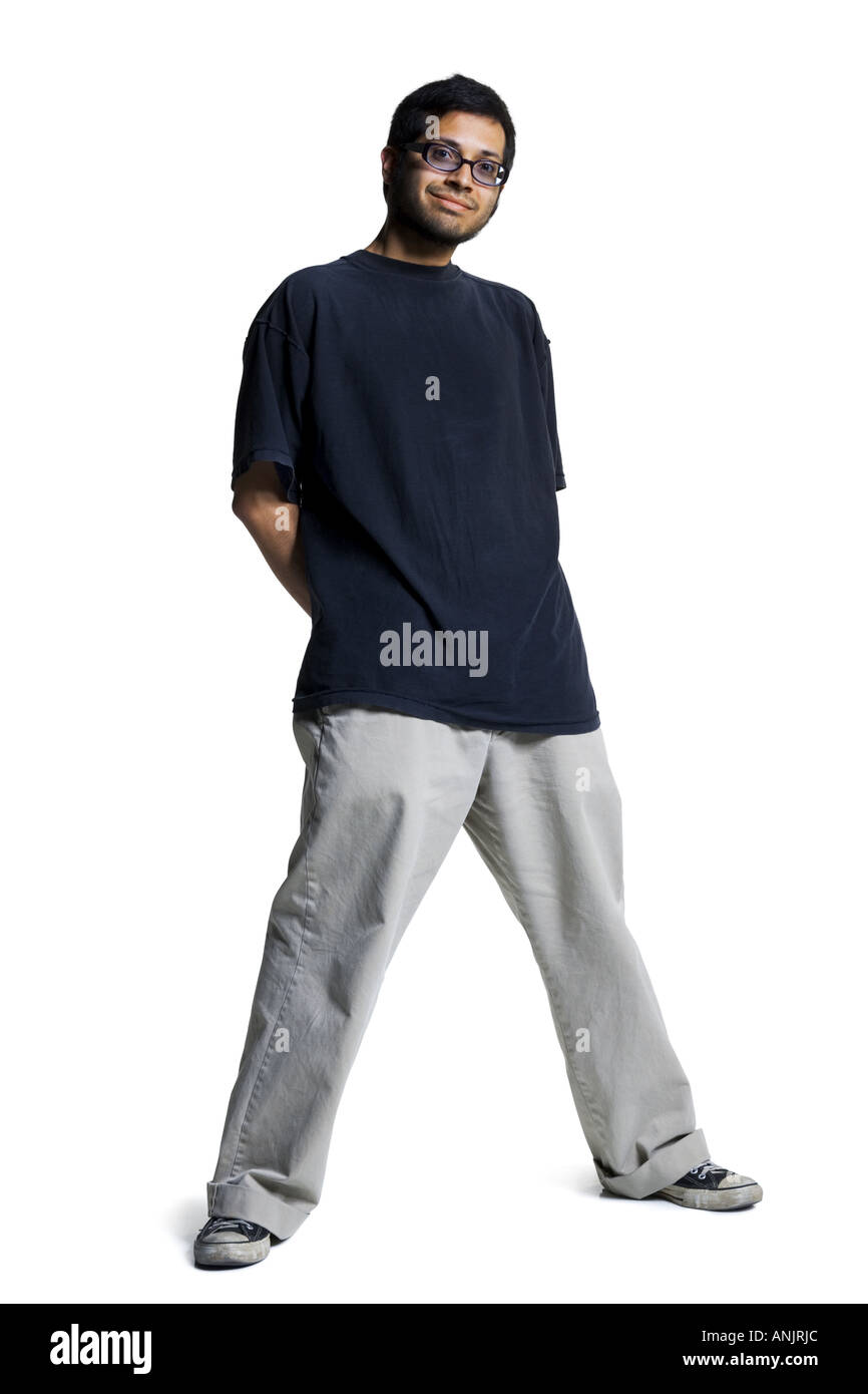 Portrait of a young man standing with his hands behind his back Stock ...
