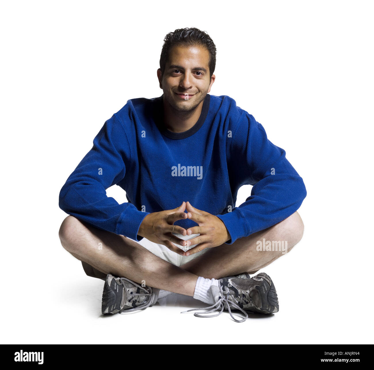 Portrait of a young man sitting with his legs crossed Stock Photo - Alamy