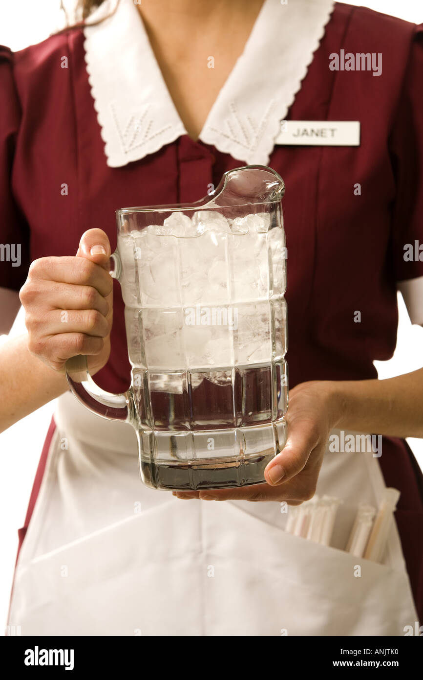 Mid section view of a waitress holding a jug of water Stock Photo - Alamy