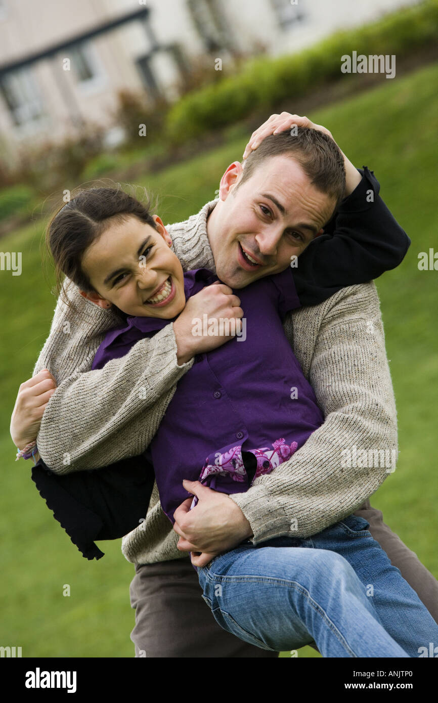 Portrait of a father hugging his daughter Stock Photo - Alamy