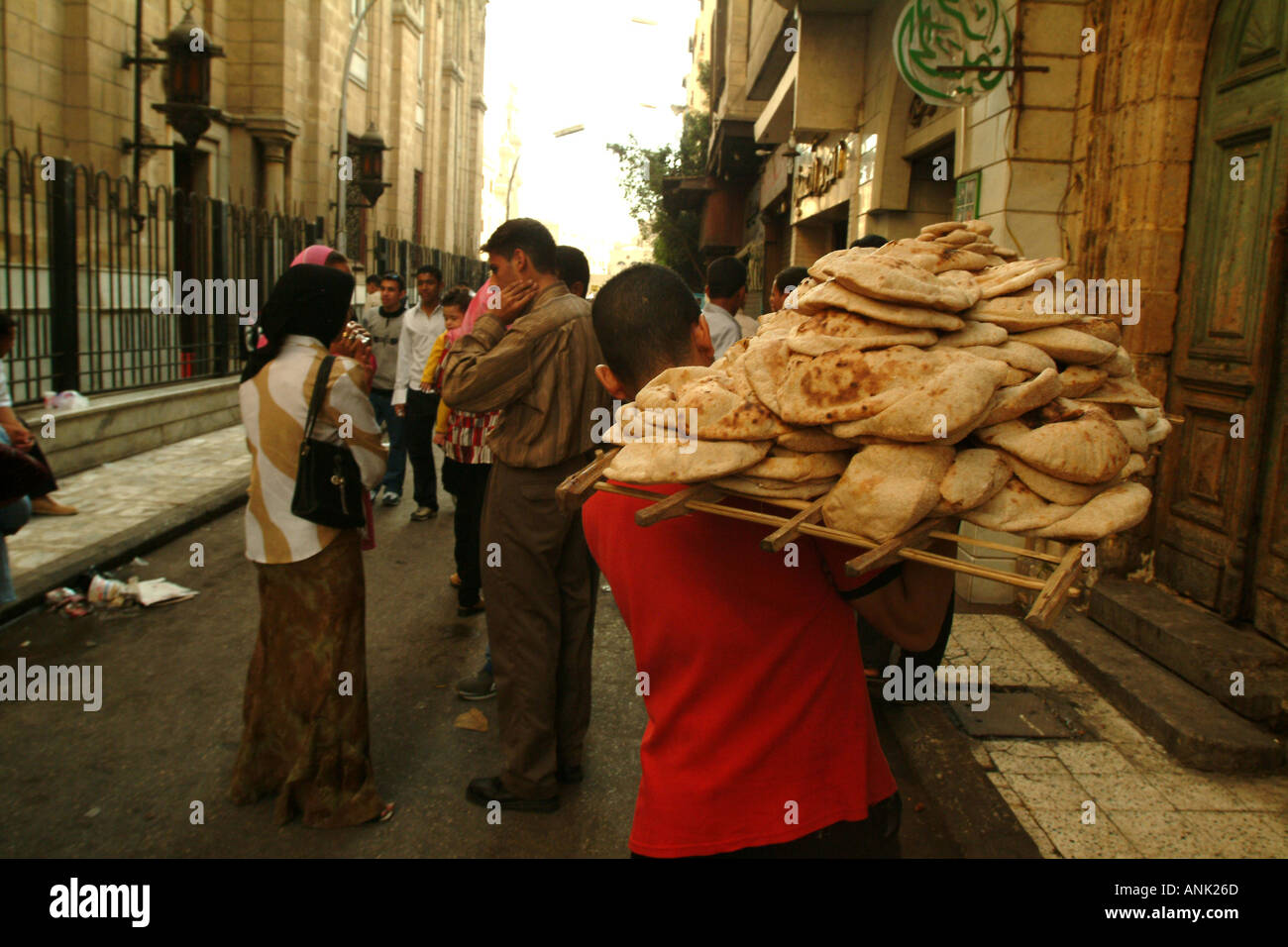 Man carrying bread through Cairo street Stock Photo - Alamy