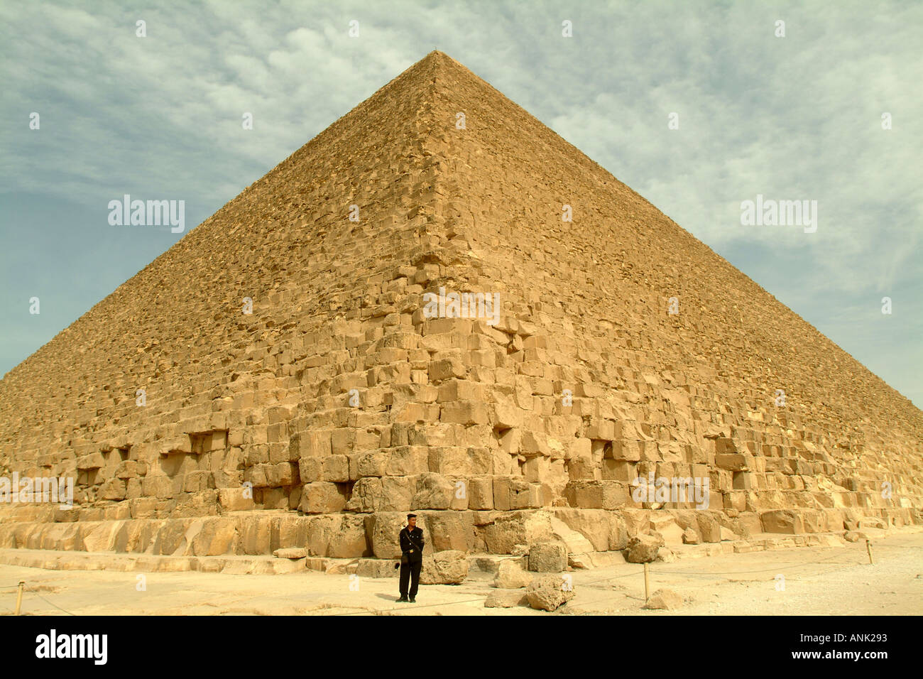 A security guard is dwarfed by the Great Pyramid of Cheops in Giza ...