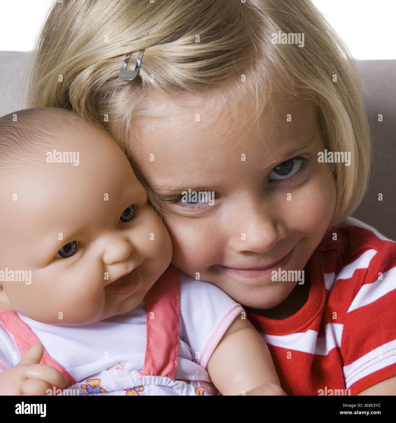 Portrait of a girl holding a doll Stock Photo - Alamy