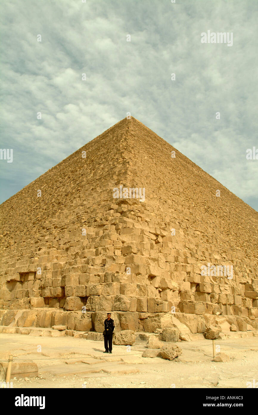 A security guard is dwarfed by the Great Pyramid of Cheops in Giza ...