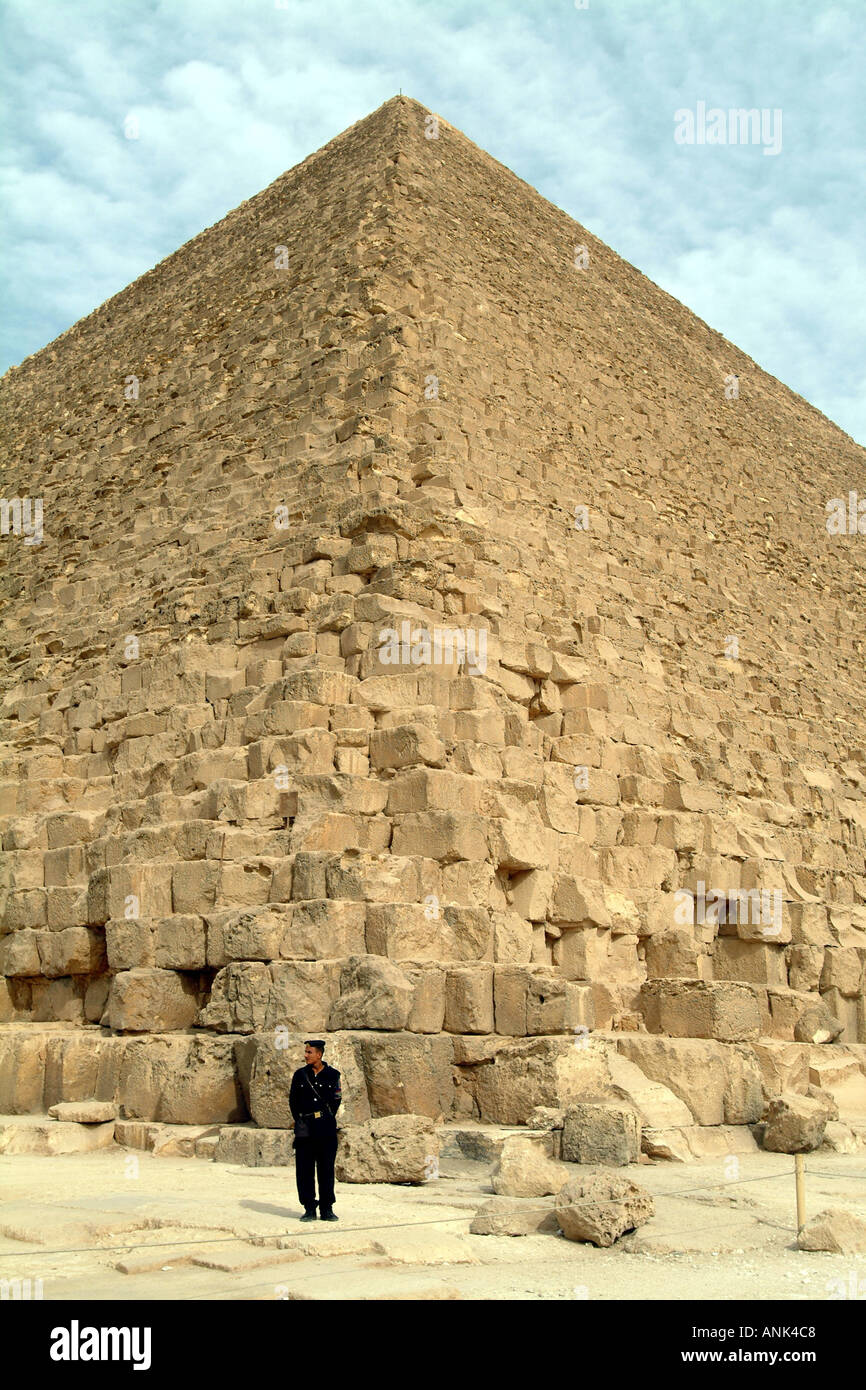A security guard is dwarfed by the Great Pyramid of Cheops in Giza ...