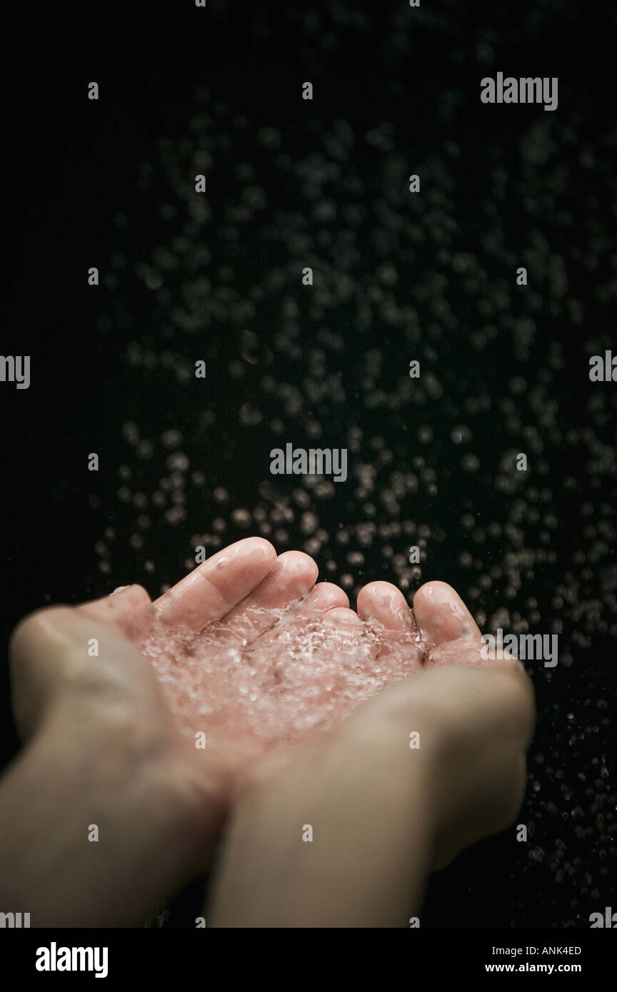 Water Running on Cupped Hands Stock Photo - Alamy