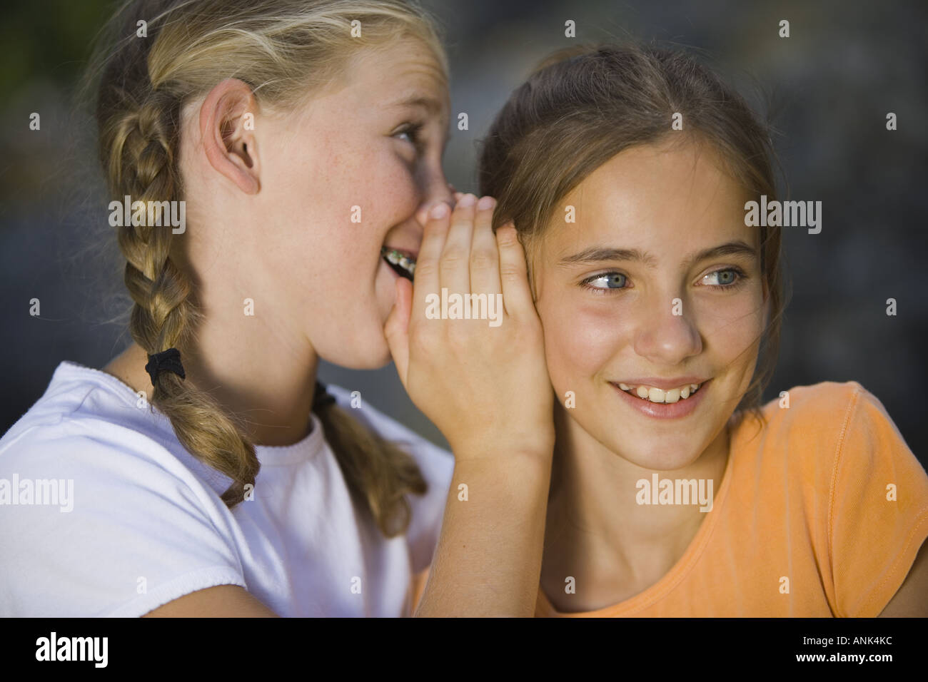 Kid friend girls whispering ear hi-res stock photography and images - Alamy