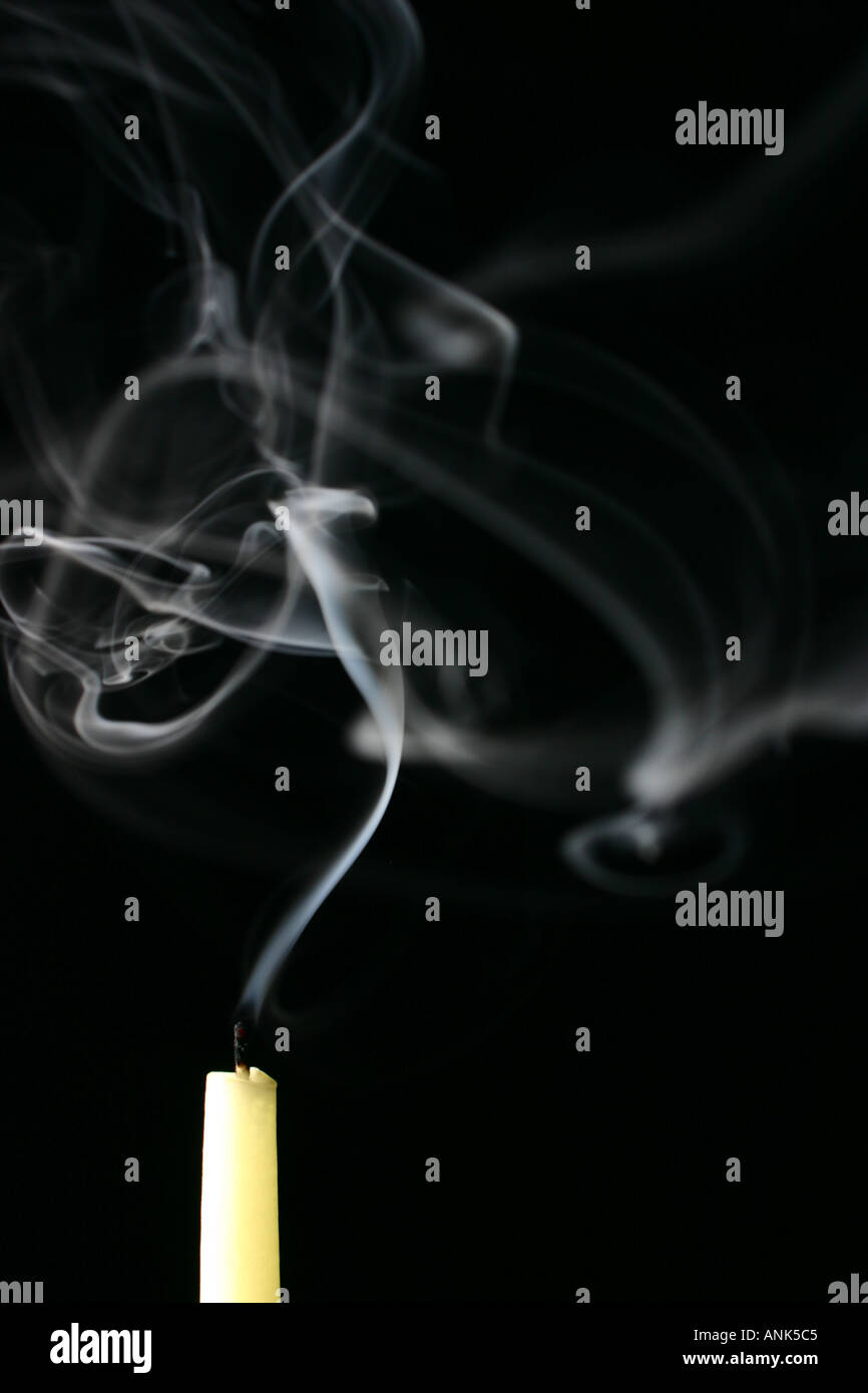 recently extinguished smoking candle against black background Stock ...
