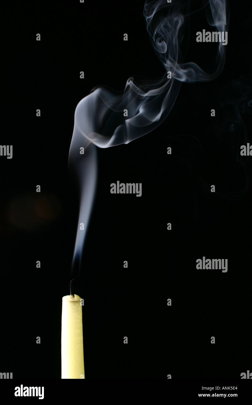 recently extinguished smoking candle against black background Stock ...