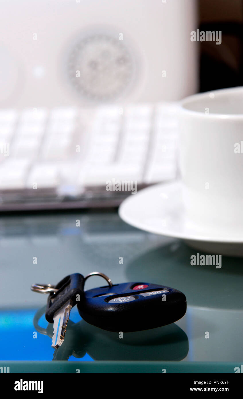 Keys sitting on desk next to computer Stock Photo - Alamy