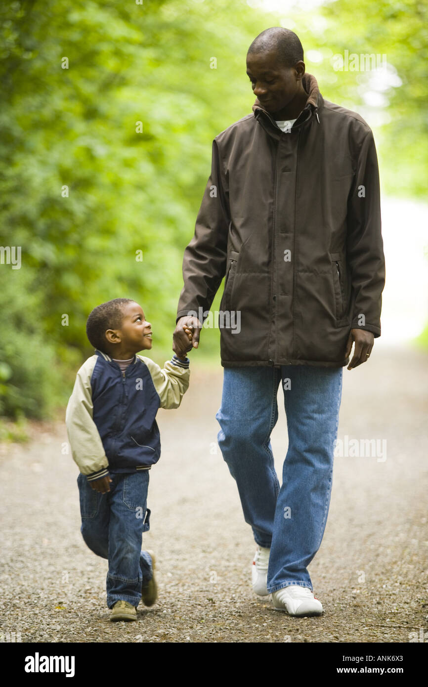 Father walking with his son outdoors Stock Photo - Alamy