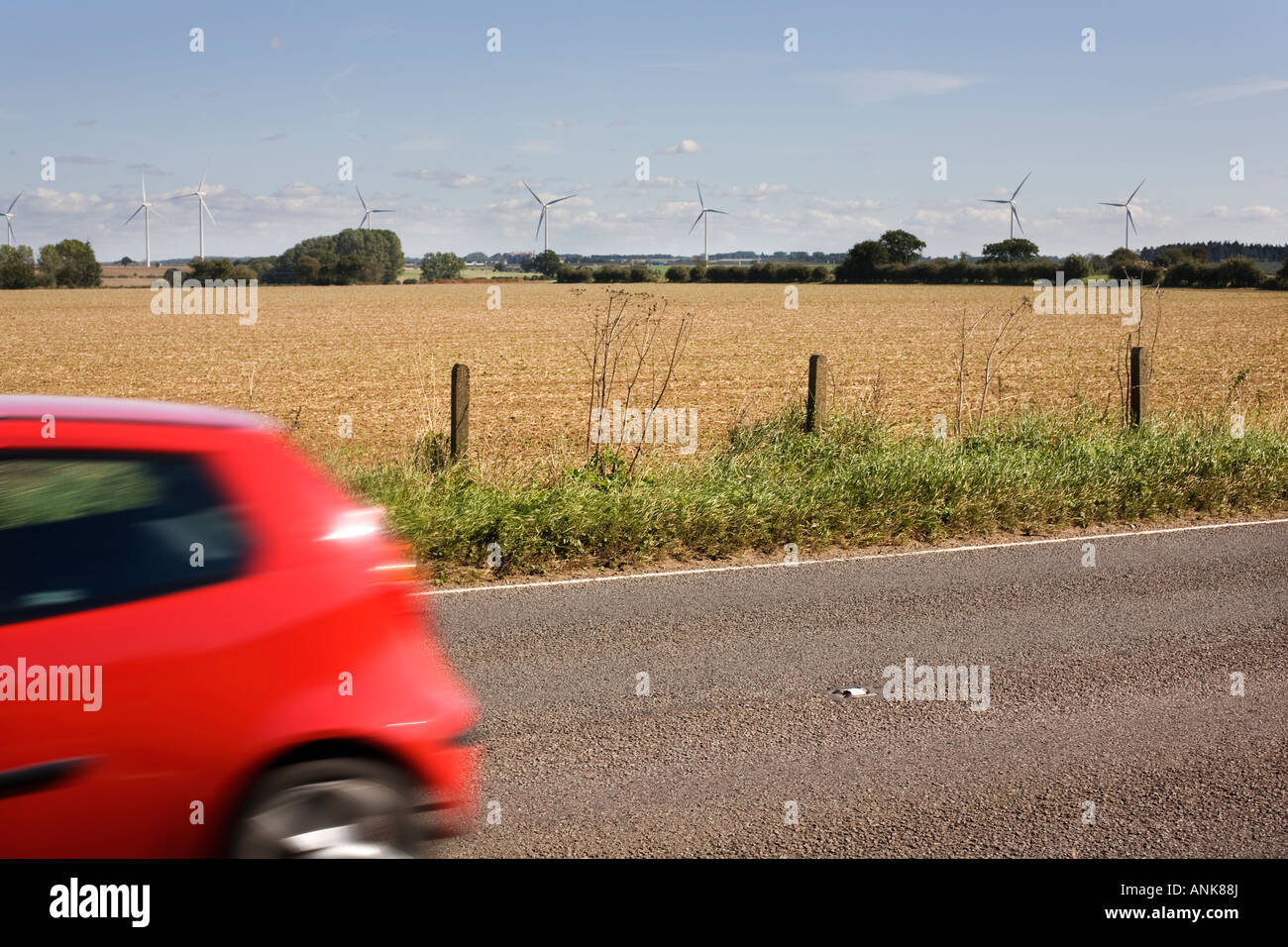 Car with wind turbines in the background Stock Photo - Alamy
