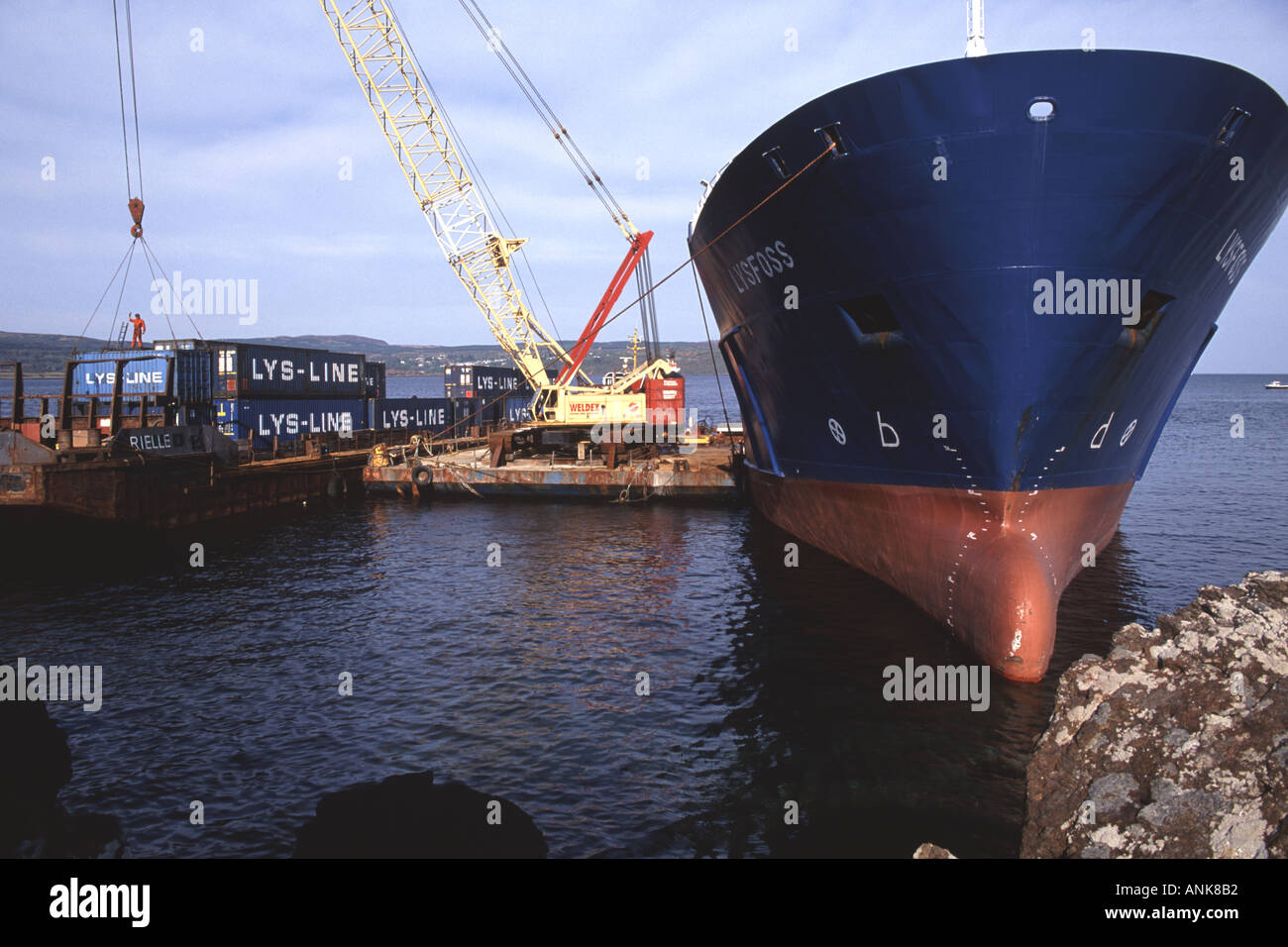 UK Scotland Sound of Mull Container ship aground on rocks with barge ...