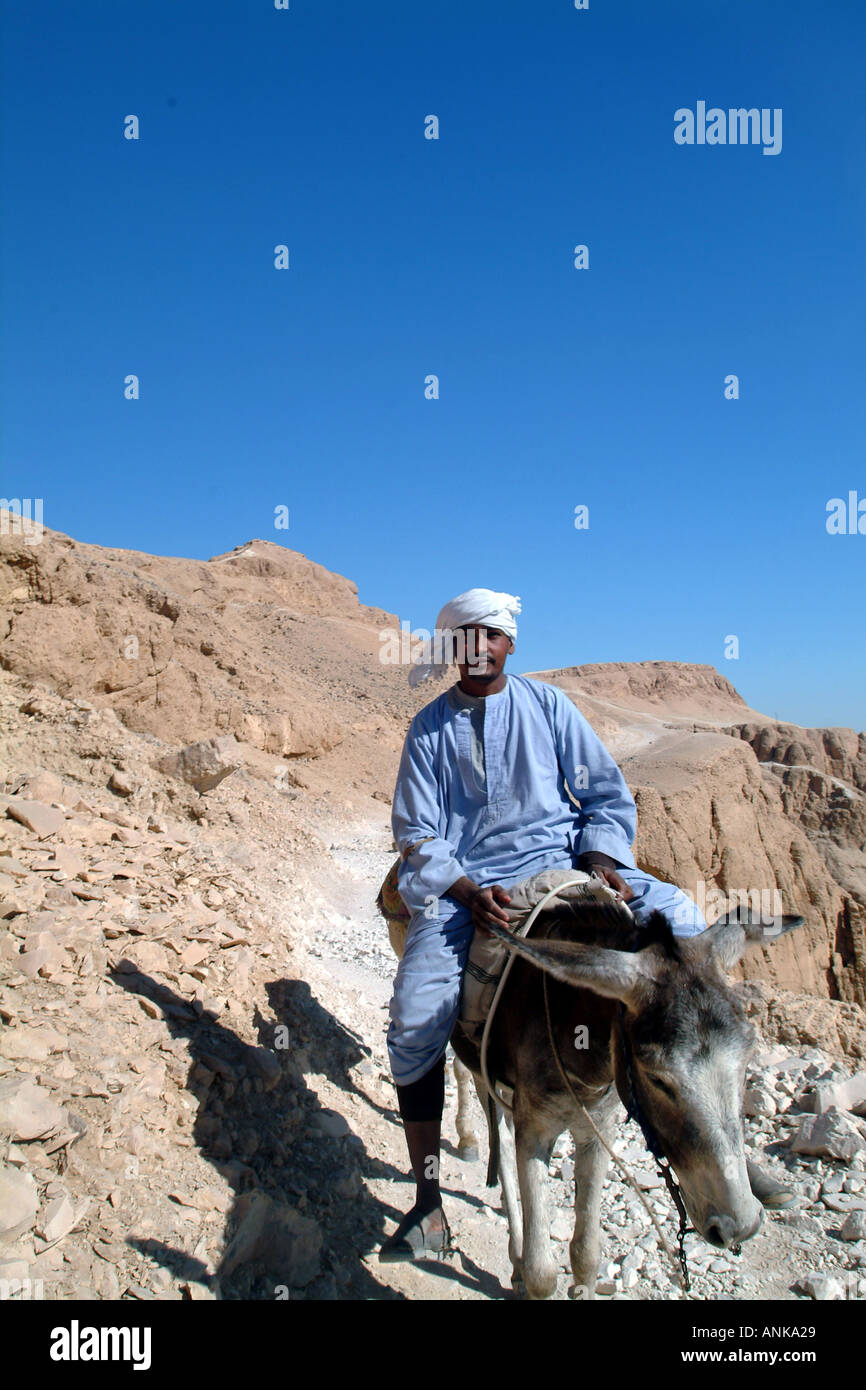Egyptian man on a donkey in the mountains above the Valley of the Kings ...