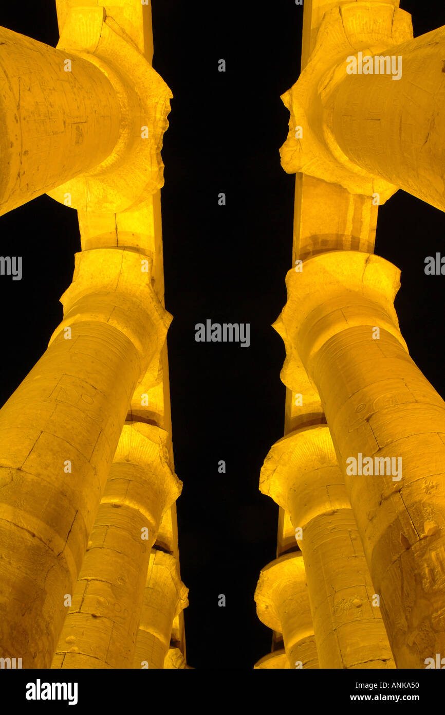 Interior of Luxor temple at night looking up the columns at the sky ...