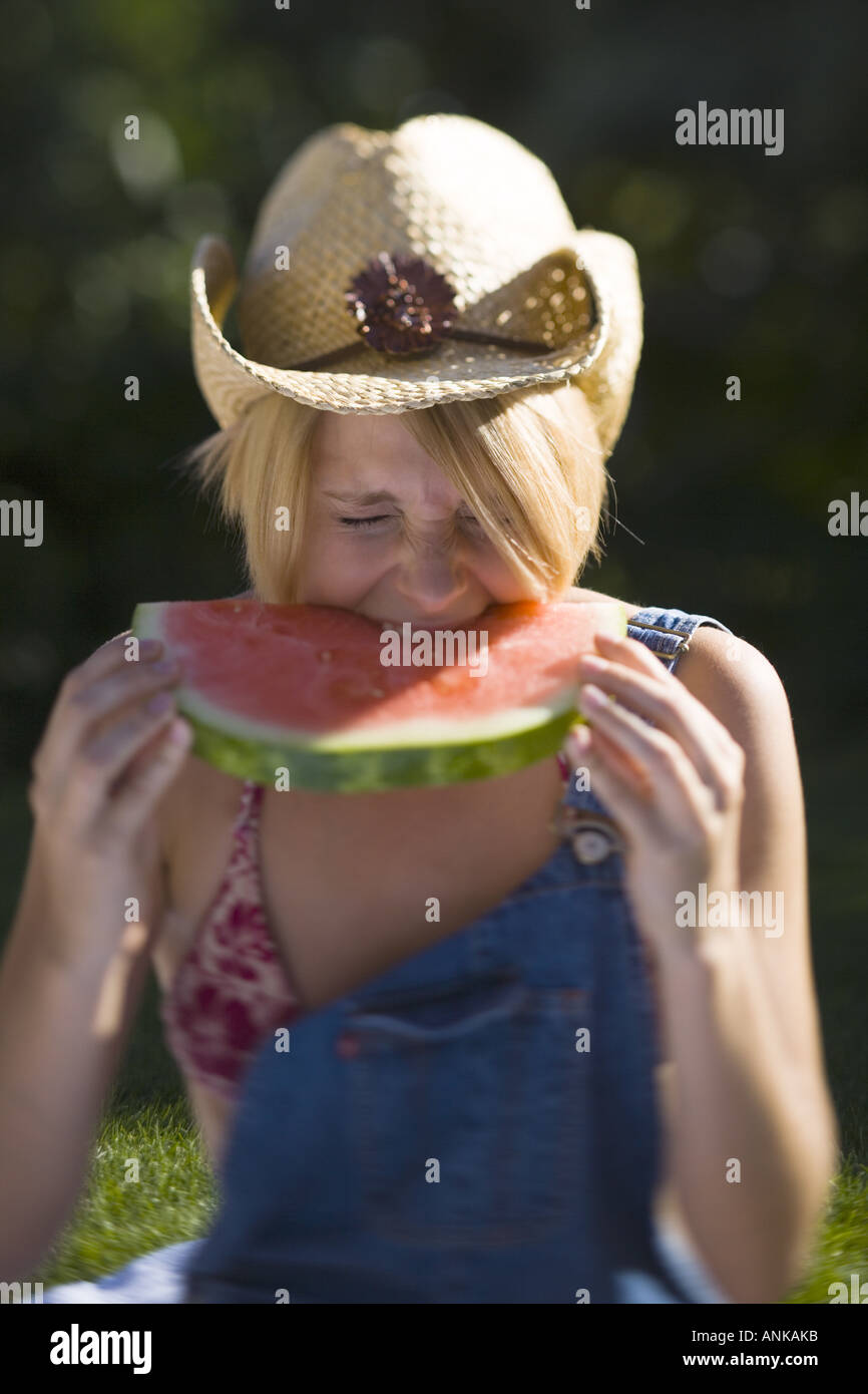 Young woman biting a piece of a watermelon Stock Photo - Alamy
