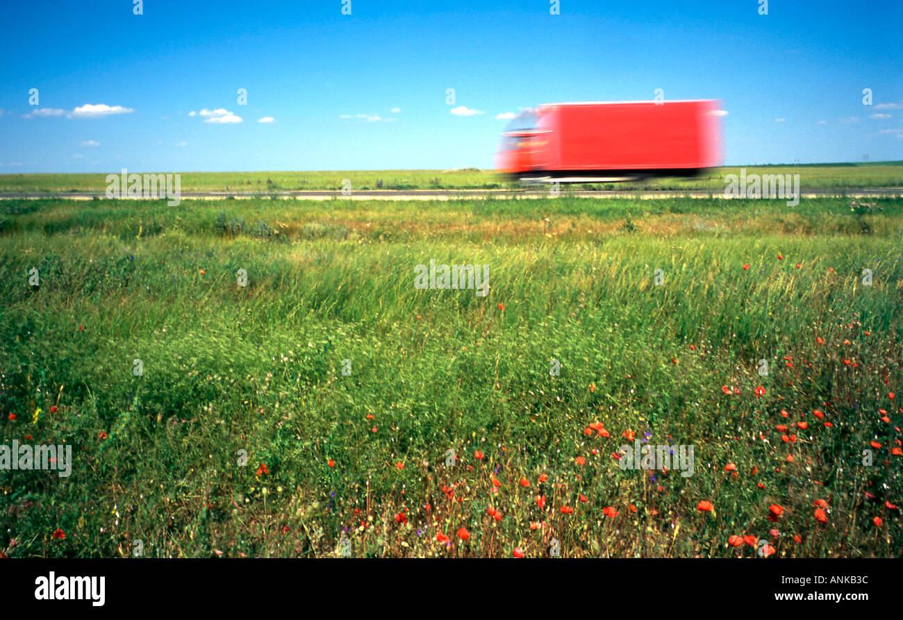 Red lorry travelling through the countryside in central Crimea Ukraine ...