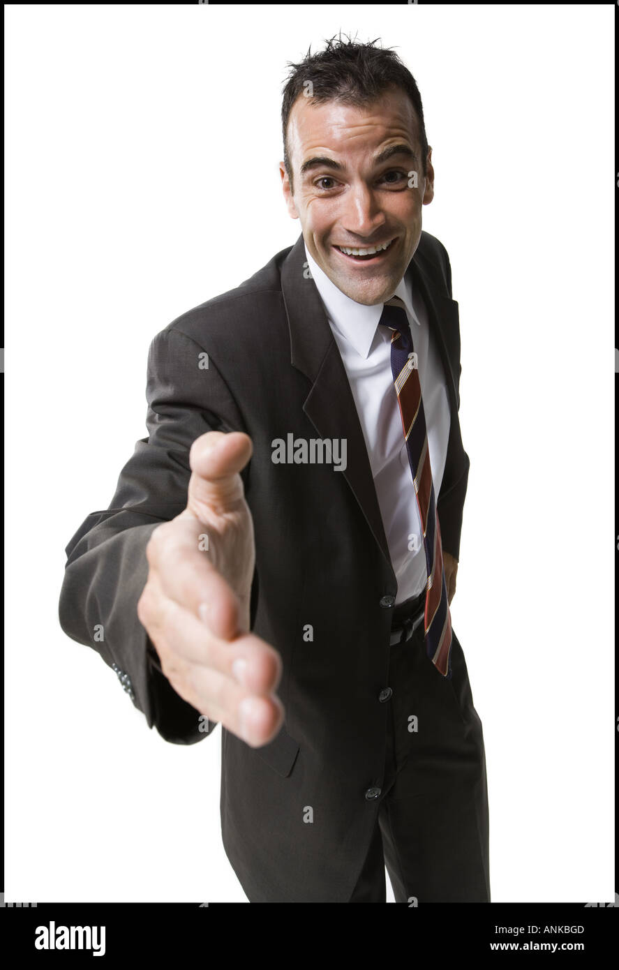 Businessman extending his hand for handshake Stock Photo - Alamy