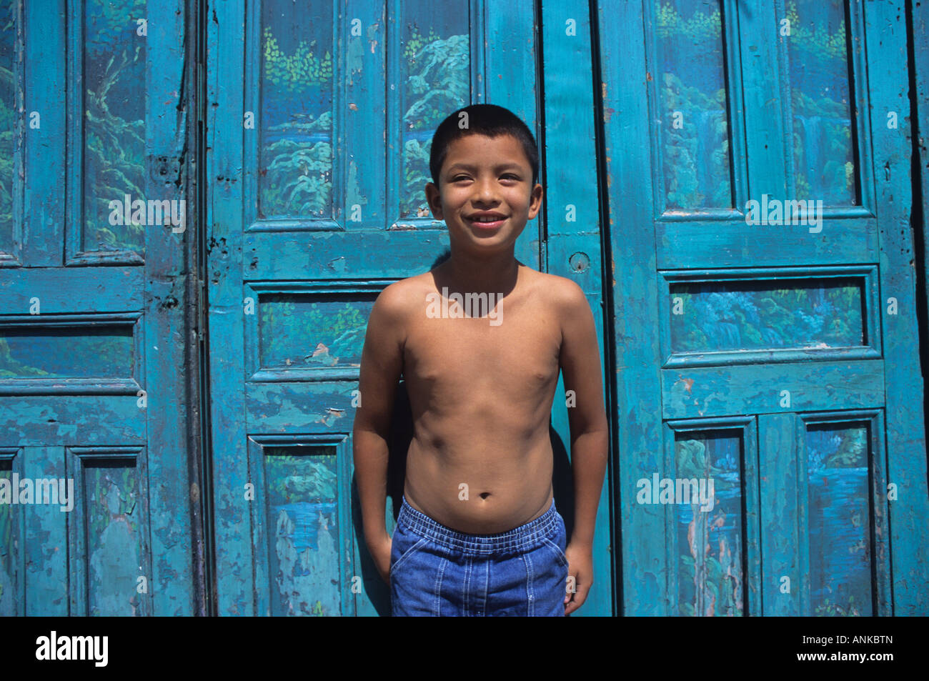 El Salvador. Young boy by traditional, colonial wooden door Stock Photo ...