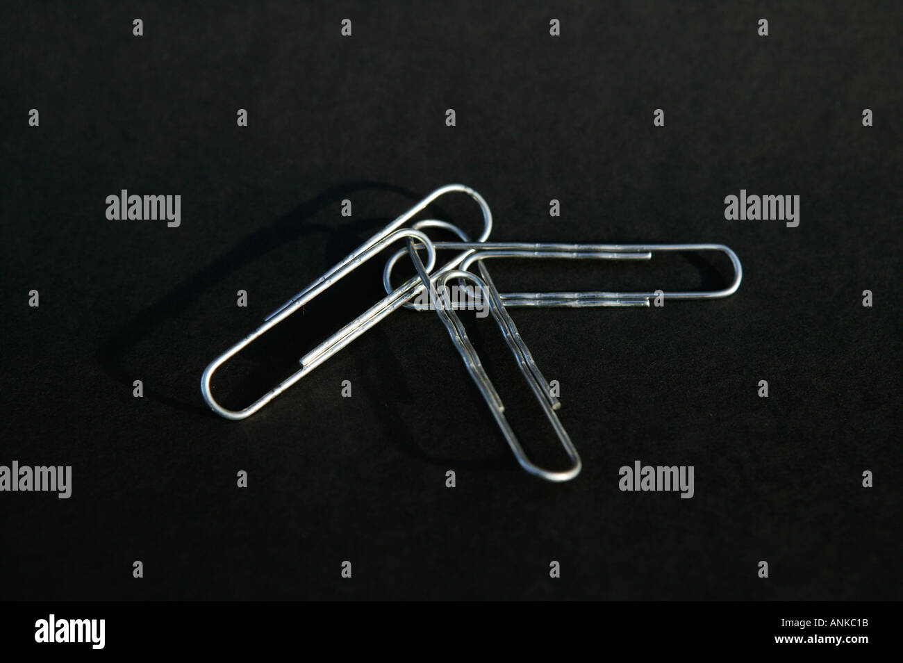 three paper clips in conceptual shape attached to one another Stock ...