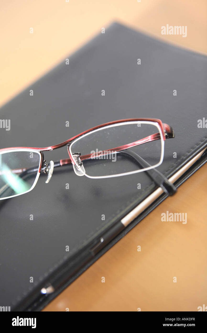 Notebook and glasses Stock Photo - Alamy