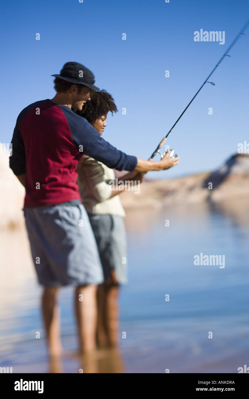 Profile of a young couple fishing Stock Photo - Alamy