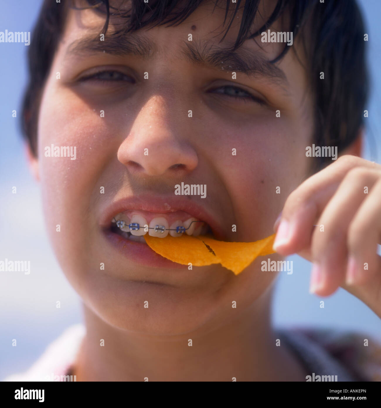 Boy eating a chip Stock Photo - Alamy