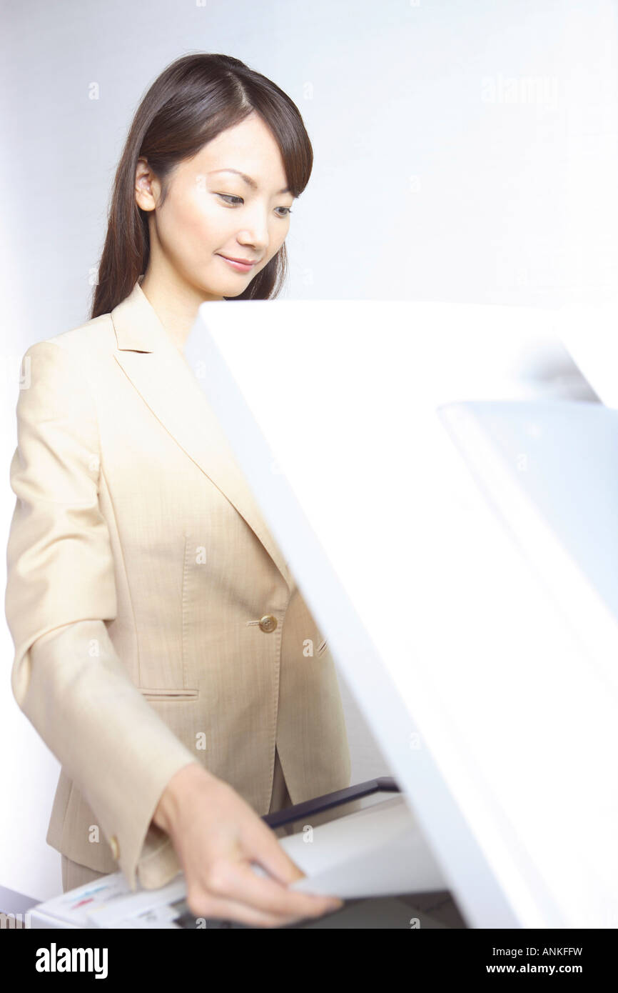 Japanese office lady taking a copy Stock Photo - Alamy