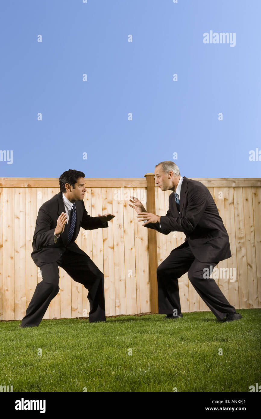 Profile of two businessmen playing and rough housing Stock Photo - Alamy