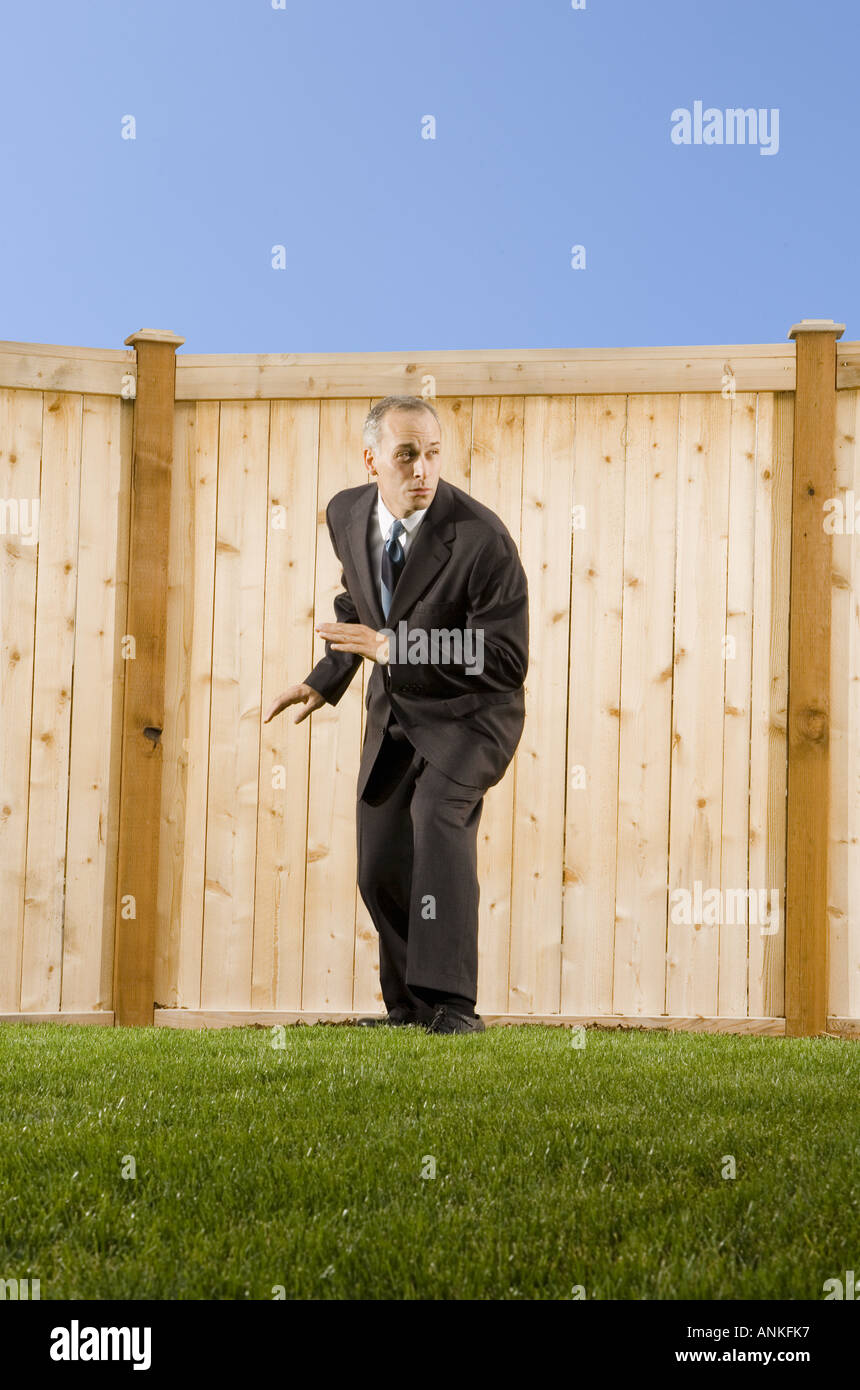 Low angle view of a businessman standing in front of a wall Stock Photo ...