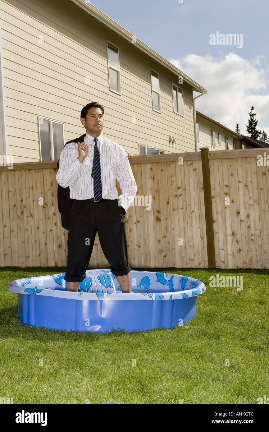 Businessman standing in a wading pool Stock Photo - Alamy