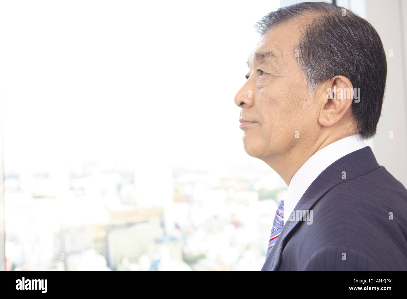 Chief executive officer looking at outside from room Stock Photo - Alamy