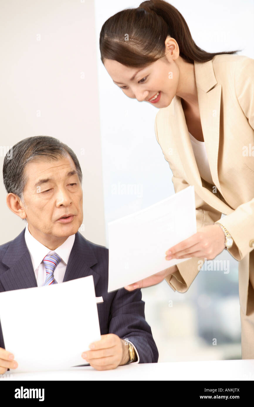 Secretary explaining about a report Stock Photo - Alamy