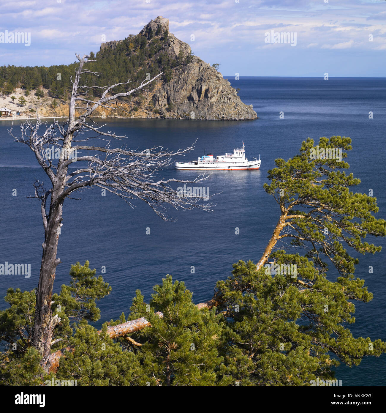 Small boat leaving the bay Stock Photo - Alamy