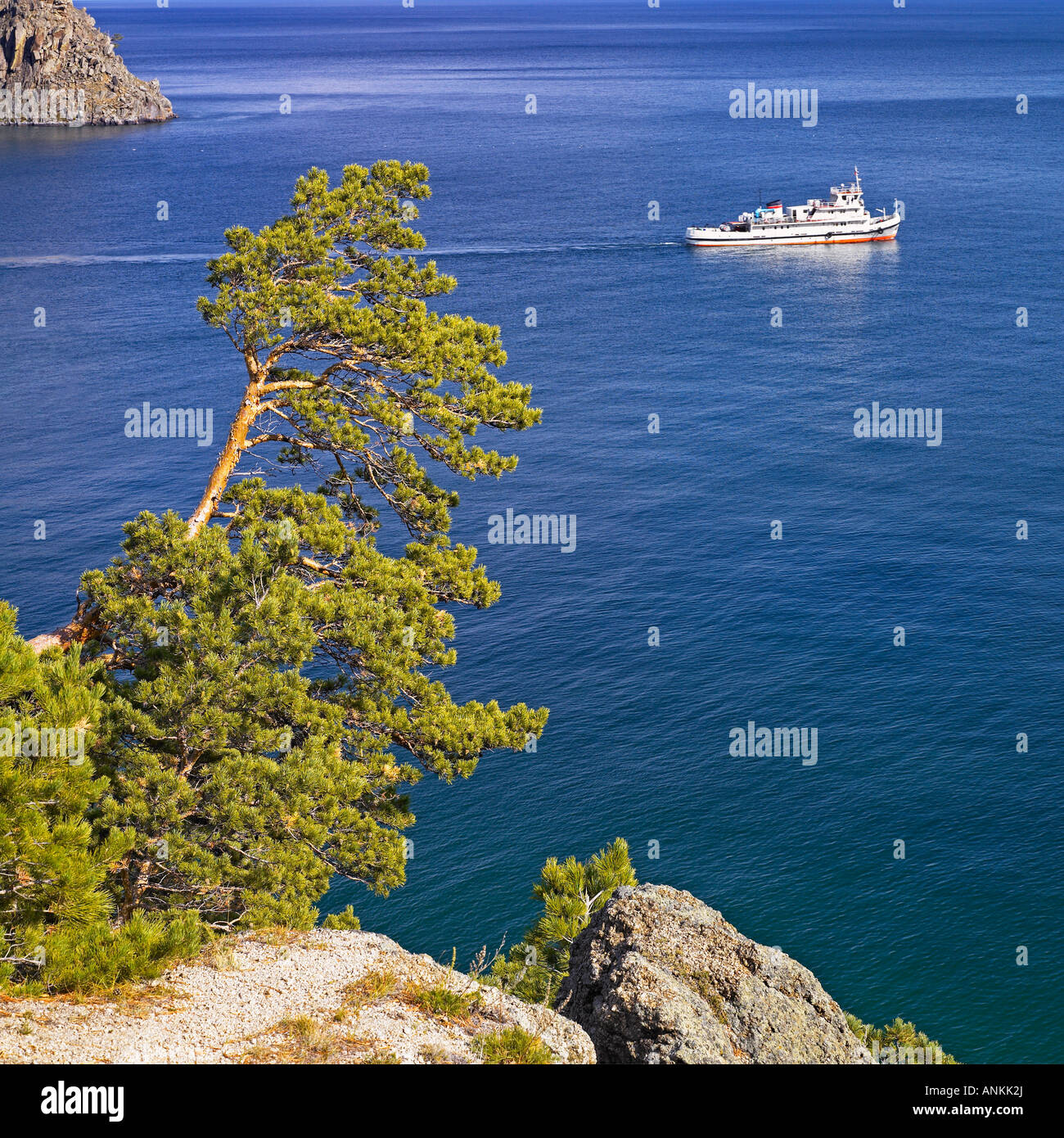 Small boat leaving the bay Stock Photo - Alamy