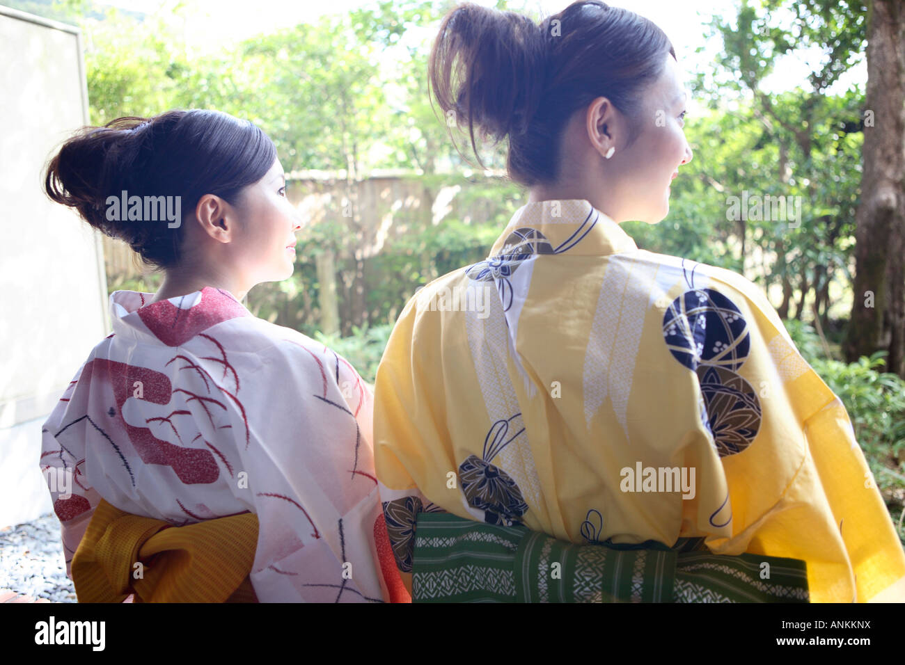 Back figure of Japanese women putting on a yukata Stock Photo - Alamy