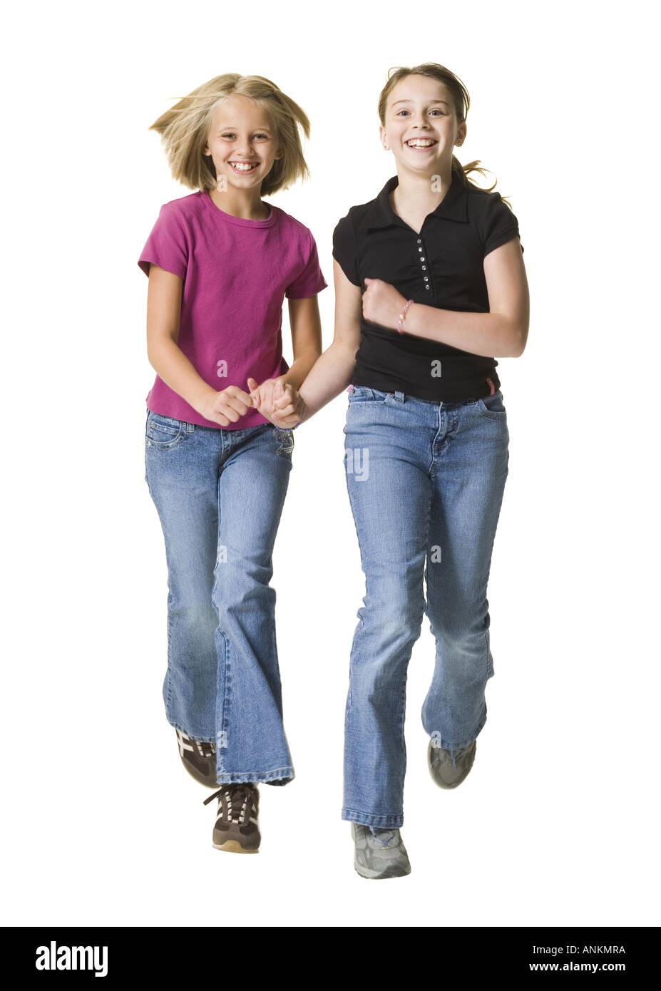 Two young girls running side by side Stock Photo - Alamy
