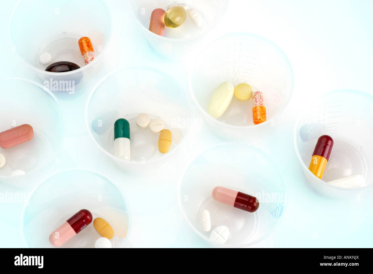 Pills in plastic cups Stock Photo - Alamy