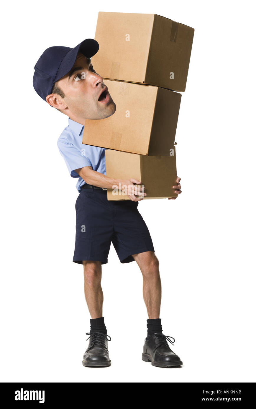 Delivery man holding cardboard boxes Stock Photo - Alamy